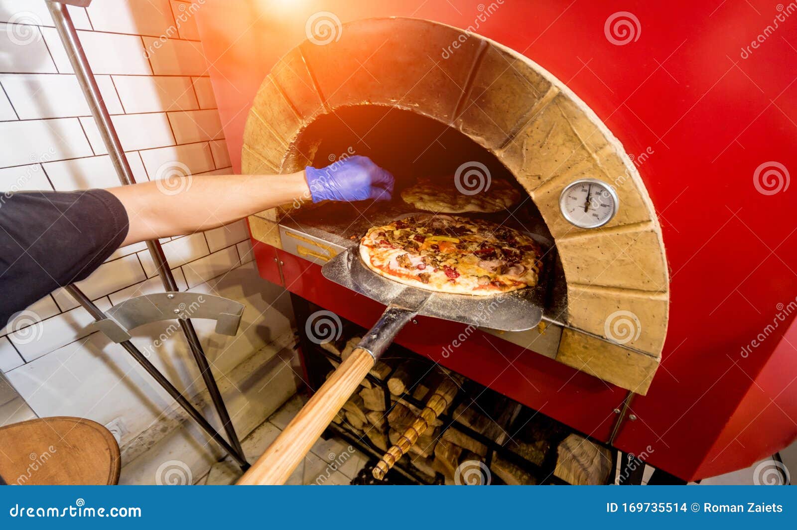 The Process of Making Pizza. Chef Baker Puts Raw Pizza in the Oven ...