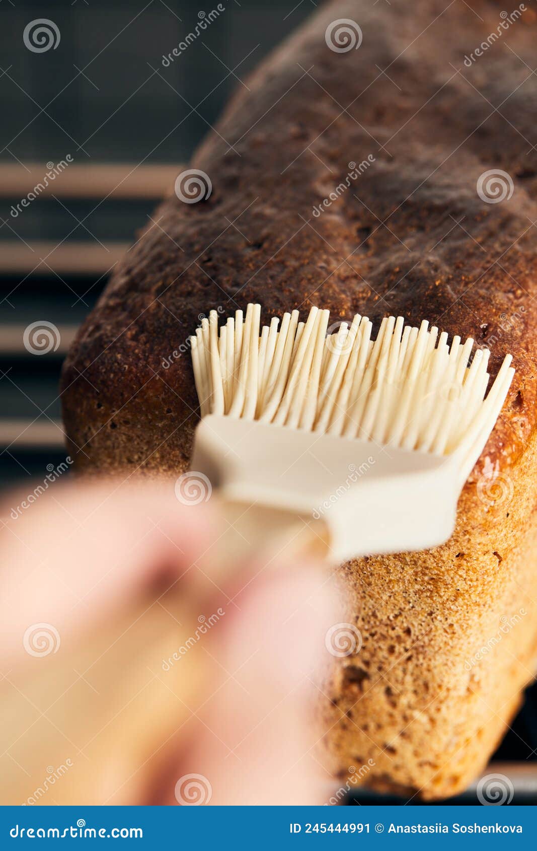The Process of Making Rye Molded Bread. Coating the Finished Bread with ...