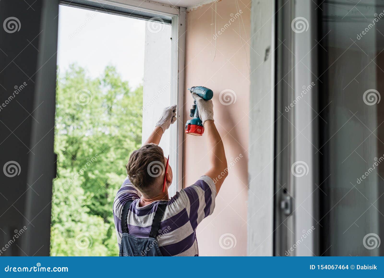Process of Man Using Screwdriver. Worker Makes the Installation of ...