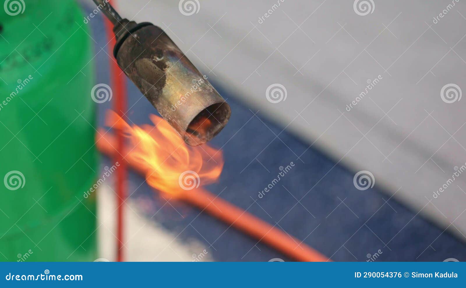 Process of Melting Roll of Tar Onto the Foundation of a House Under ...