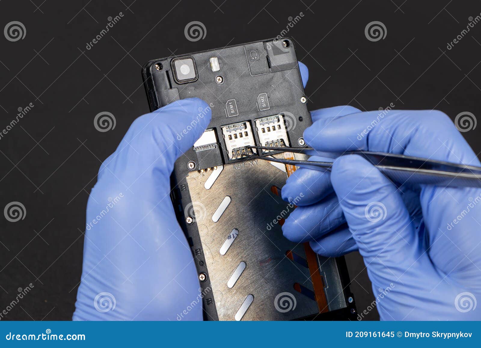 Process of Mobile Phone Repair. Hands of a Service Worker Repairing ...