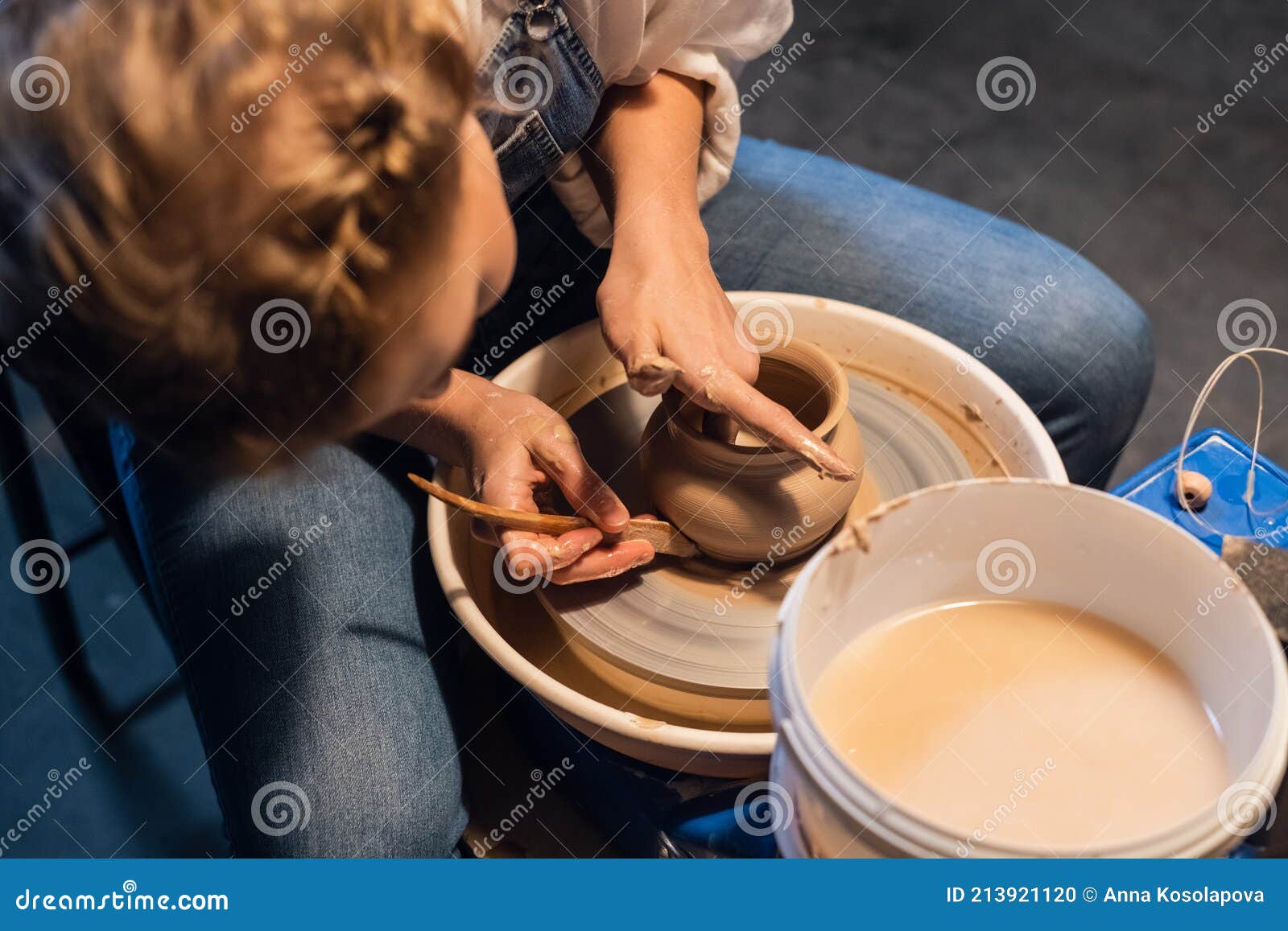 The Process of Modeling a Clay Vase Shows a Young Potter in His Studio ...