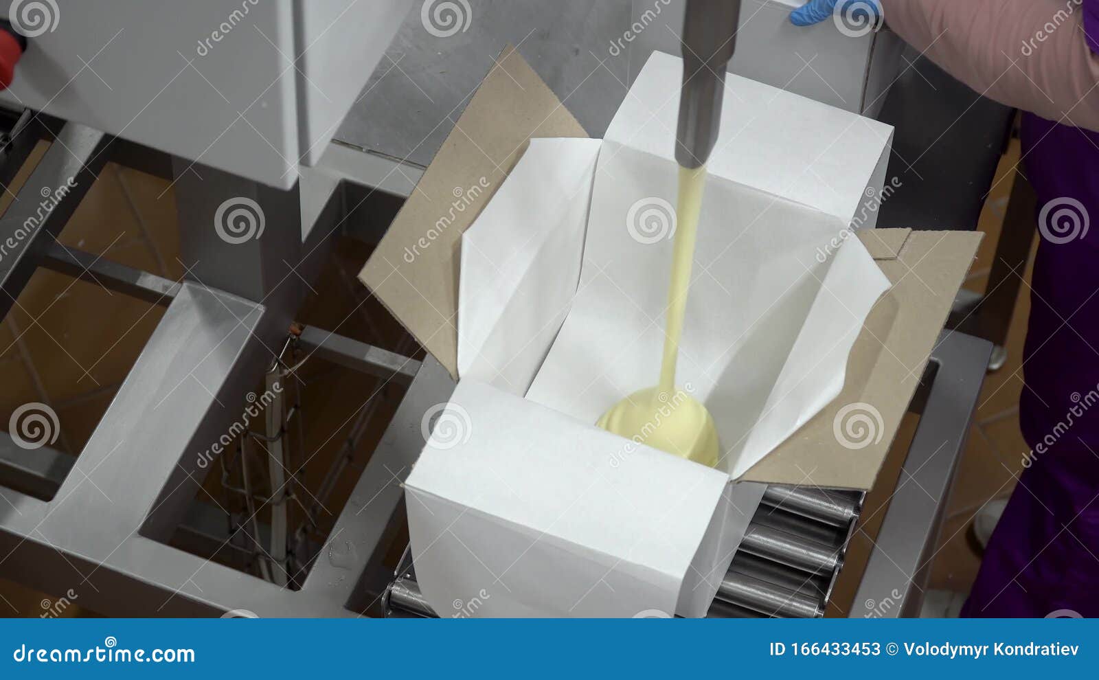 The Process of Packing Oil into Boxes. Closeup View of Packing Machine ...