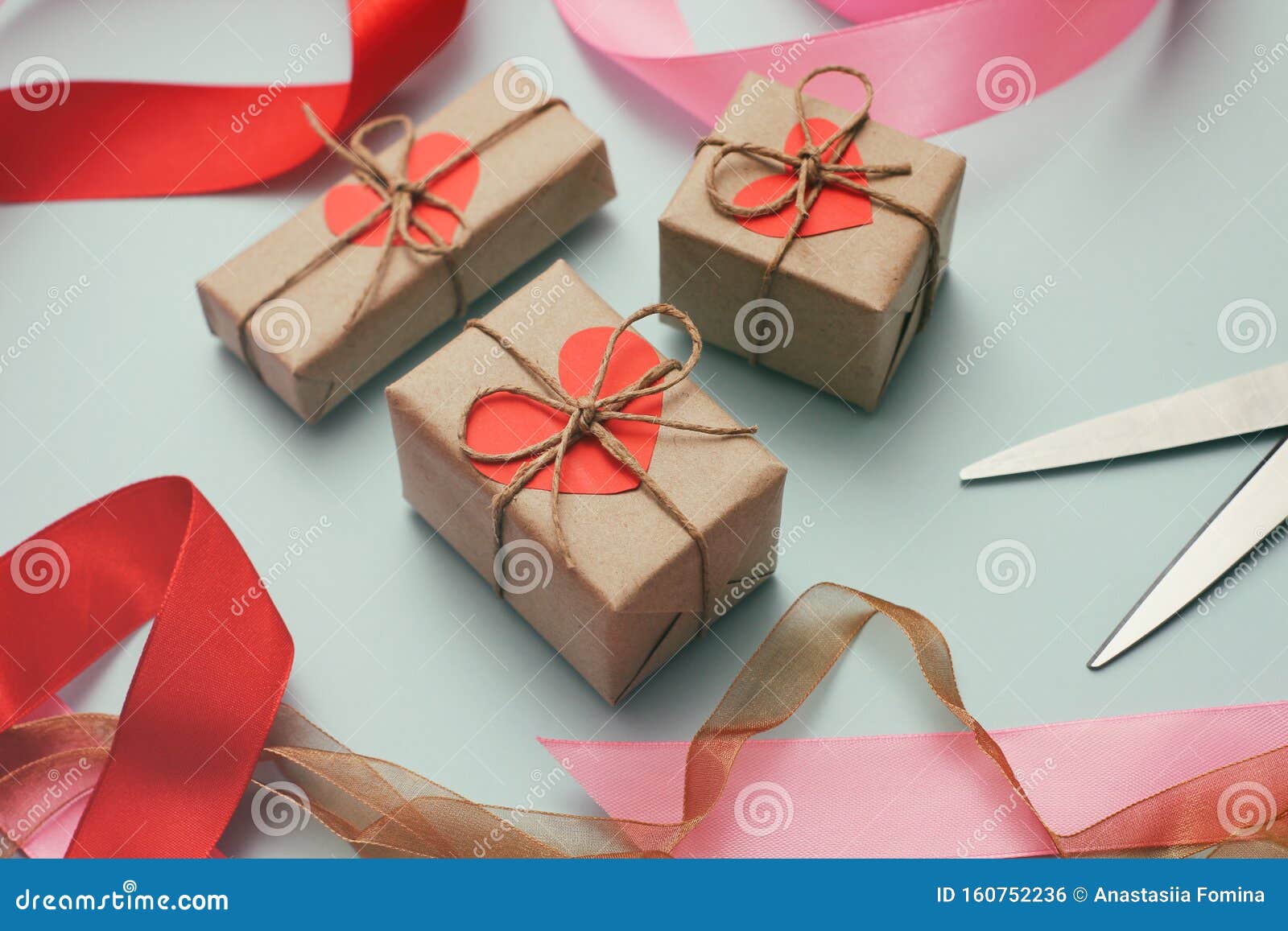 Process of Packing Presents in Gift Boxes. Craft Paper, Scissors, Hemp ...