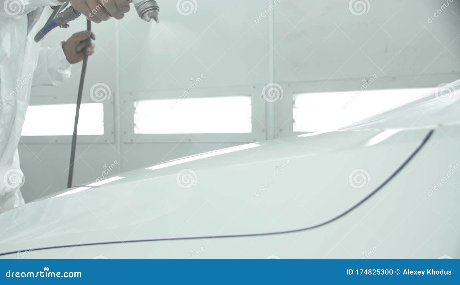 Process of Painting a White Car in a Spray Booth. Man Using a Spray Gun ...