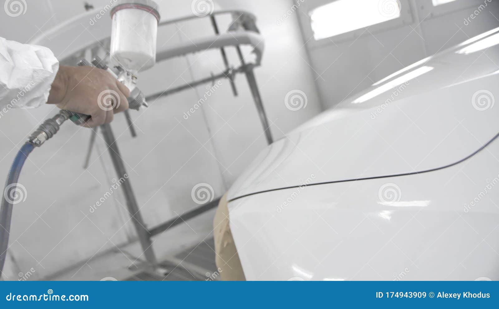 Process of Painting a White Car in a Spray Booth. Man Using a Spray Gun ...