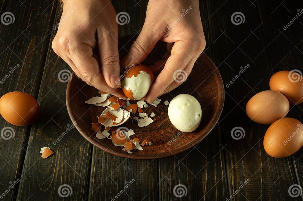 The Process of Peeling Eggs by the Hands of a Cook on the Kitchen Table ...