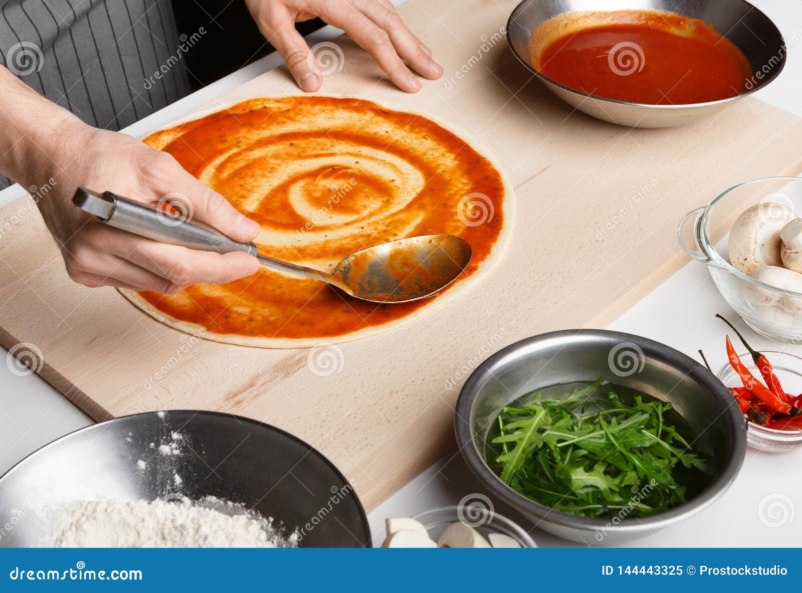Process of Pizza Preparation. Chef Spreading Tomato Sauce Stock Image ...