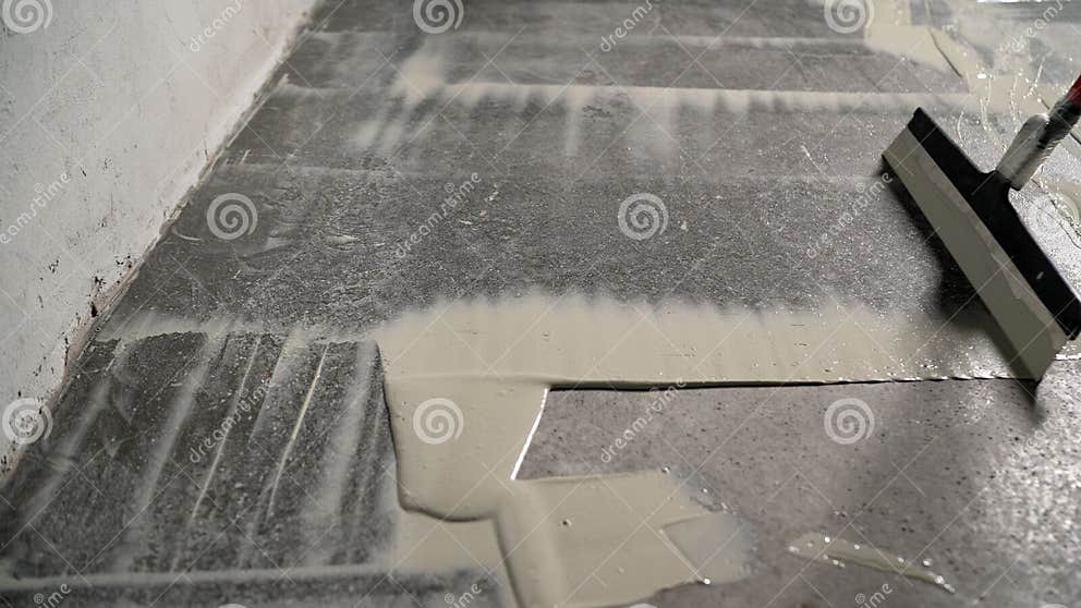 The Process of Priming a Floor with a Solution. Waterproofing Concrete ...