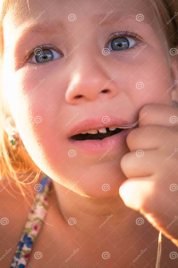 The Process of Removing a Baby Tooth Using a Thread Stock Image - Image ...