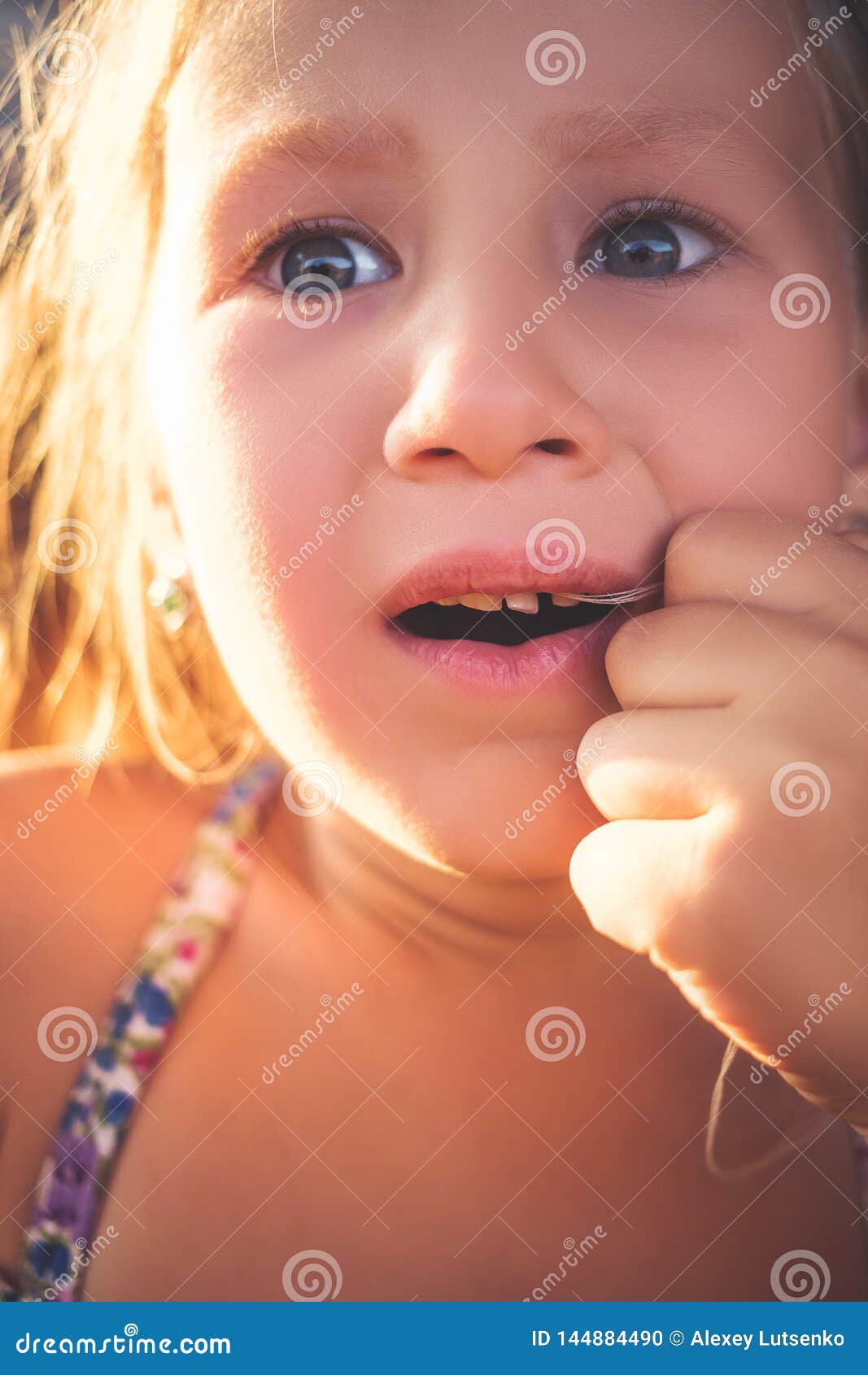 The Process of Removing a Baby Tooth Using a Thread Stock Photo - Image ...