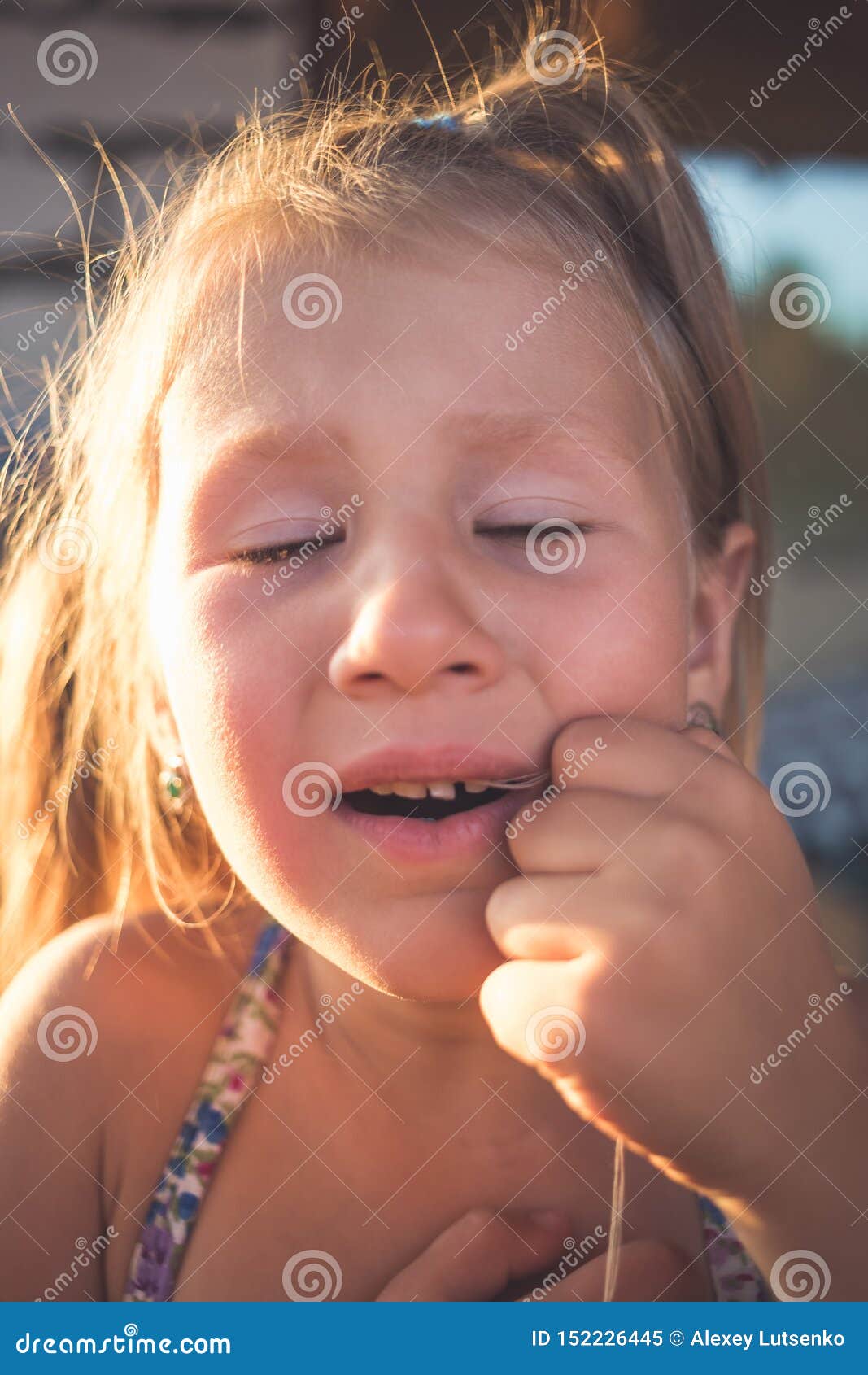 The Process of Removing a Baby Tooth Using a Thread Stock Image - Image ...