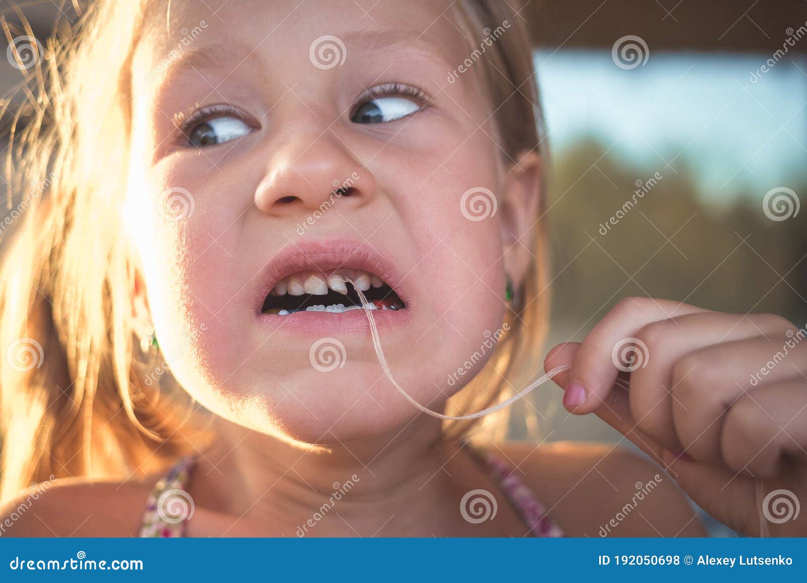 The Process of Removing a Baby Tooth Using a Thread Stock Photo - Image ...