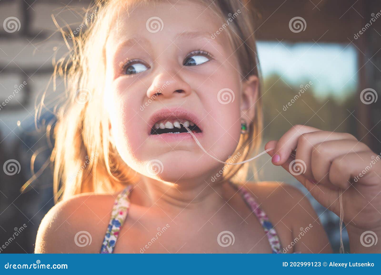 The Process of Removing a Baby Tooth Using a Thread Stock Image - Image ...