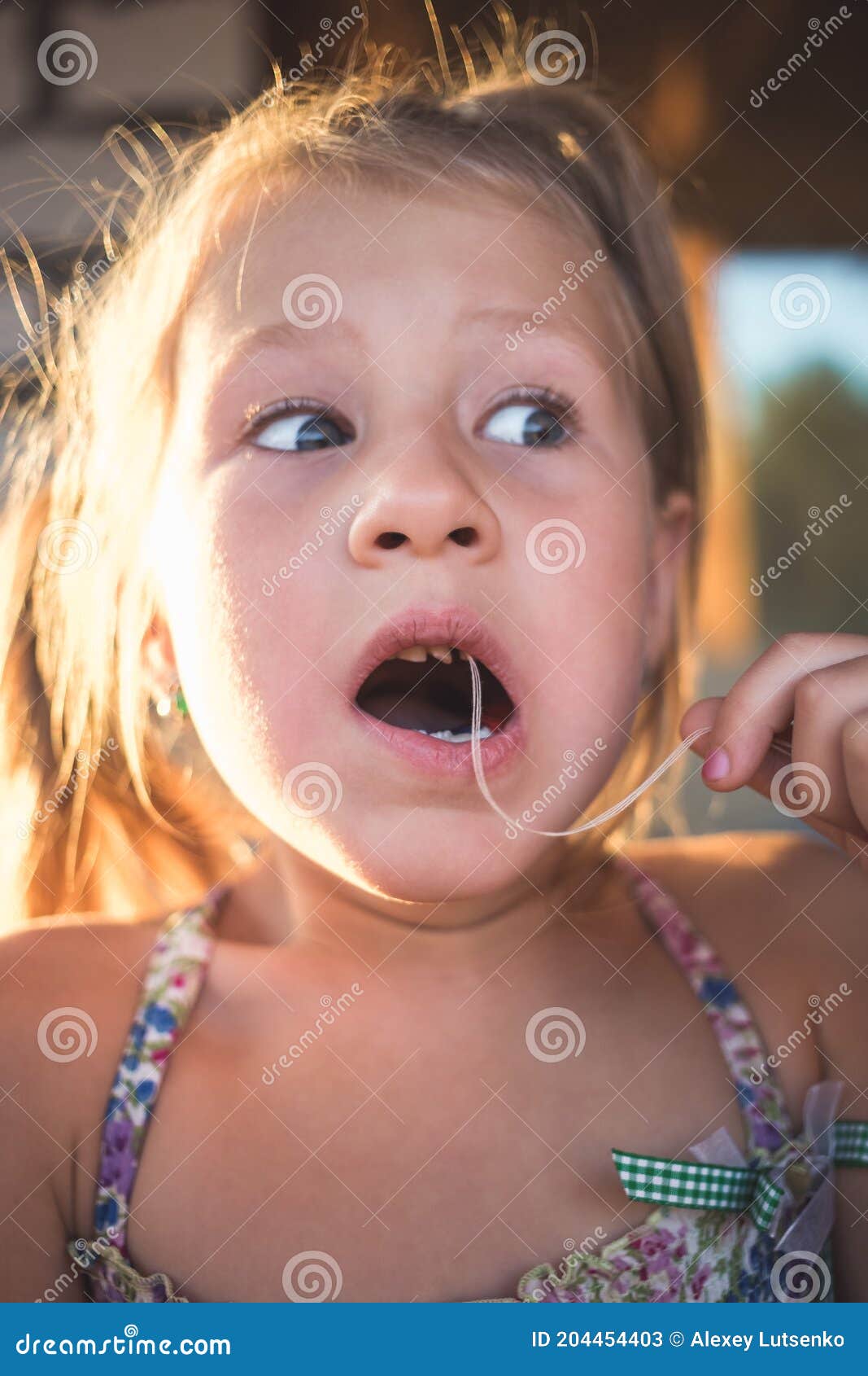 The Process of Removing a Baby Tooth Using a Thread Stock Image - Image ...