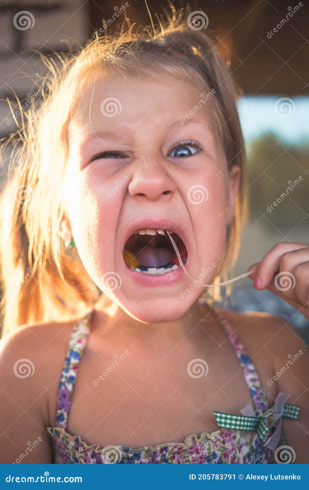 The Process of Removing a Baby Tooth Using a Thread Stock Image - Image ...