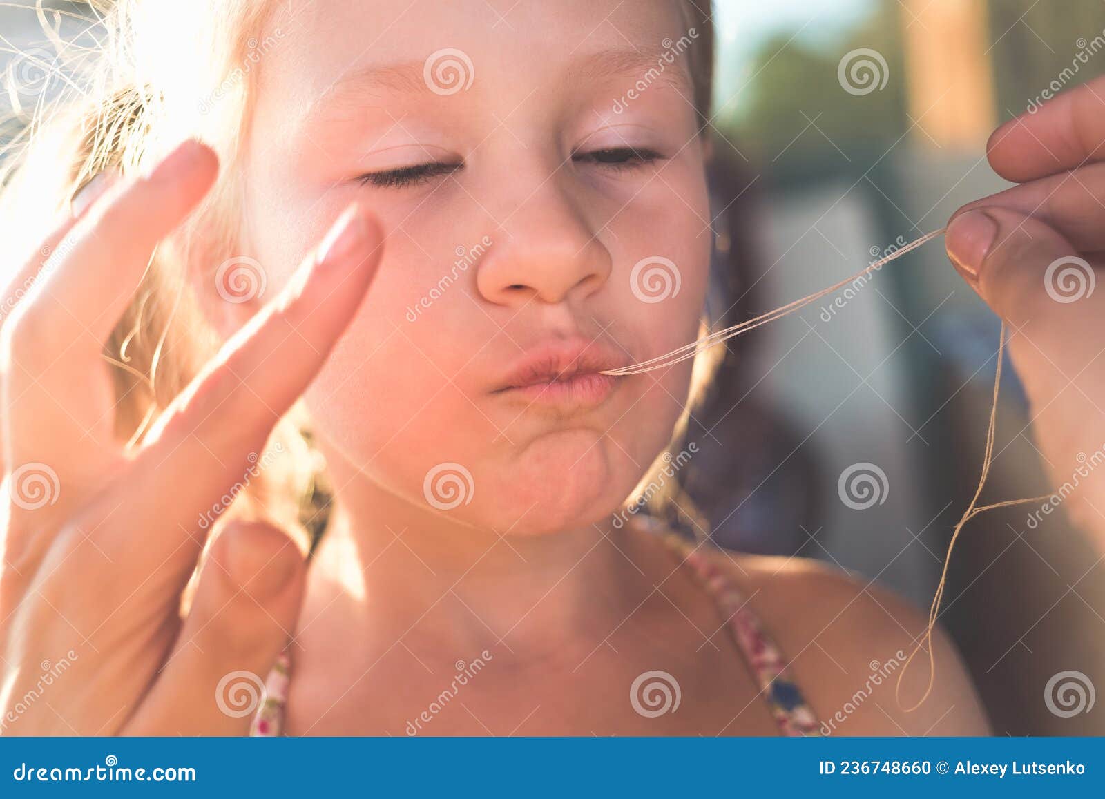 The Process of Removing a Baby Tooth Using a Thread Stock Photo - Image ...