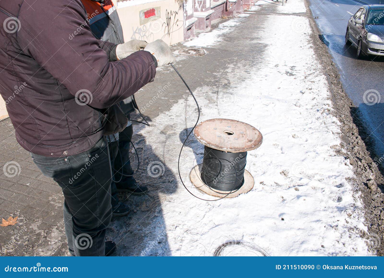 A Working Electrician Prepares Wires for Replacement. the Wire is Wound ...