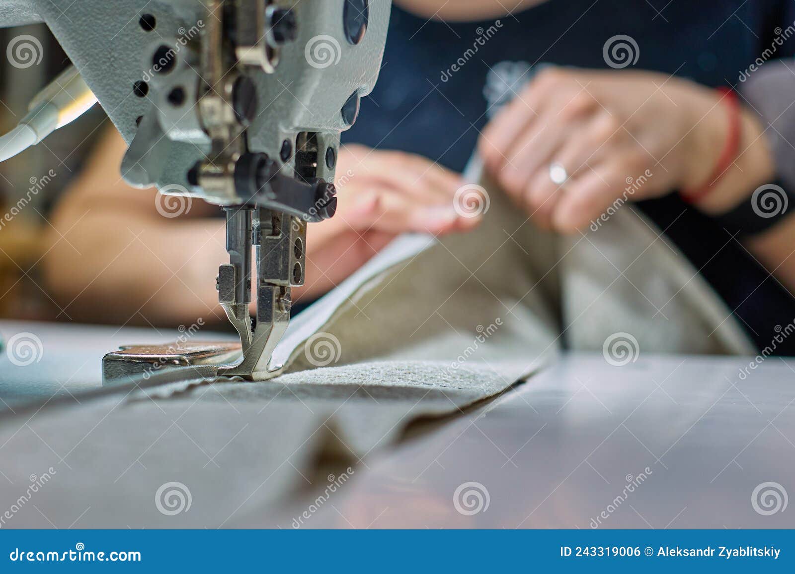 Process of a Seamstress Sewing Beige Fabric in a Sewing Workshop. Stock ...