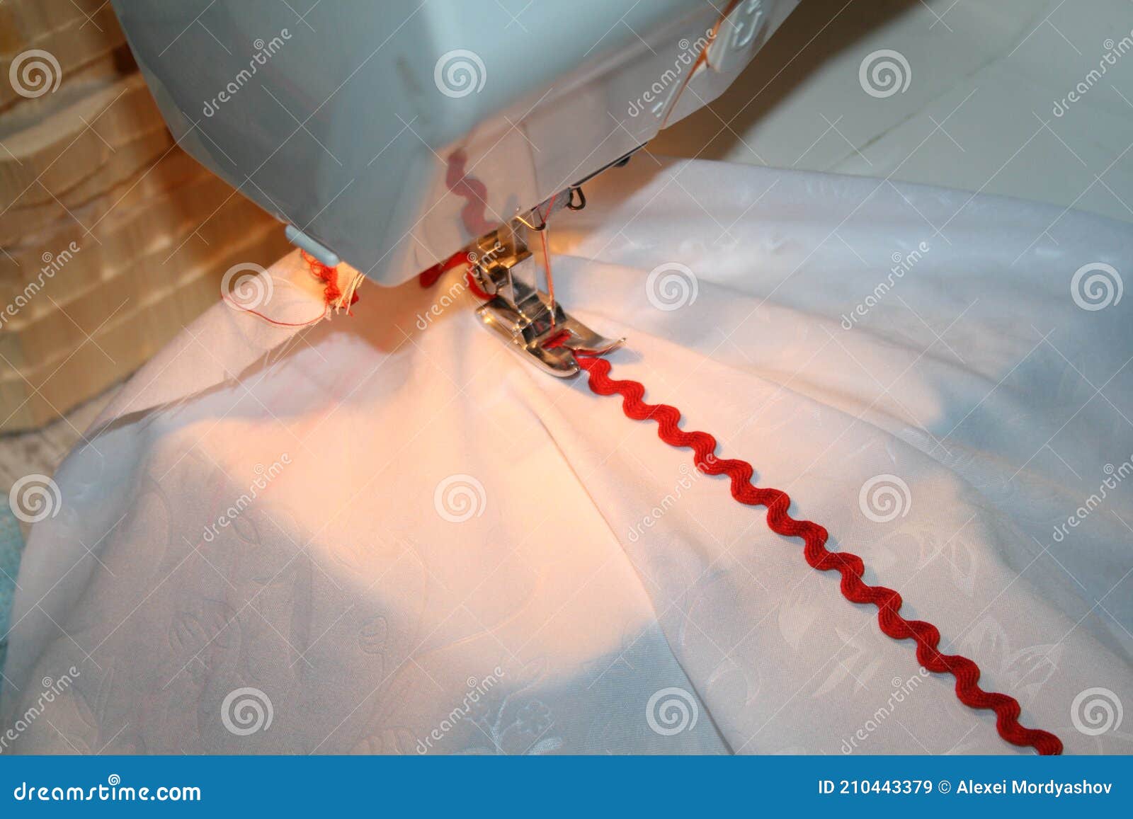 The Process of Sewing a Red Ribbon To a White Fabric Stock Image ...