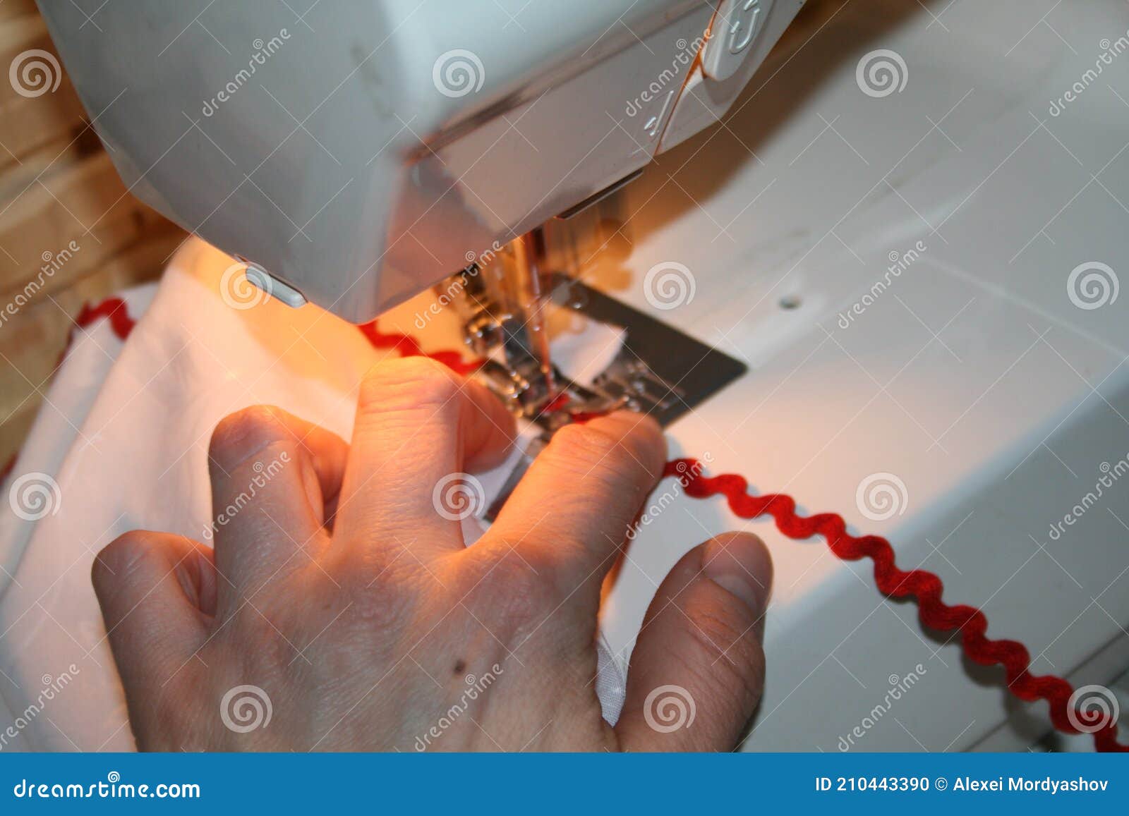 The Process of Sewing a Red Ribbon To a White Fabric Stock Photo ...
