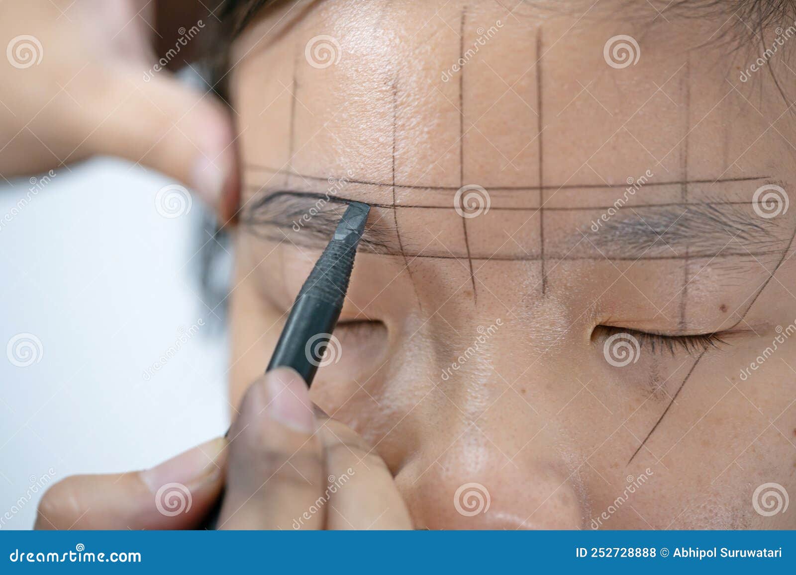 The Process of Shaping Eyebrows by a Beauty Master with a Thread for a ...