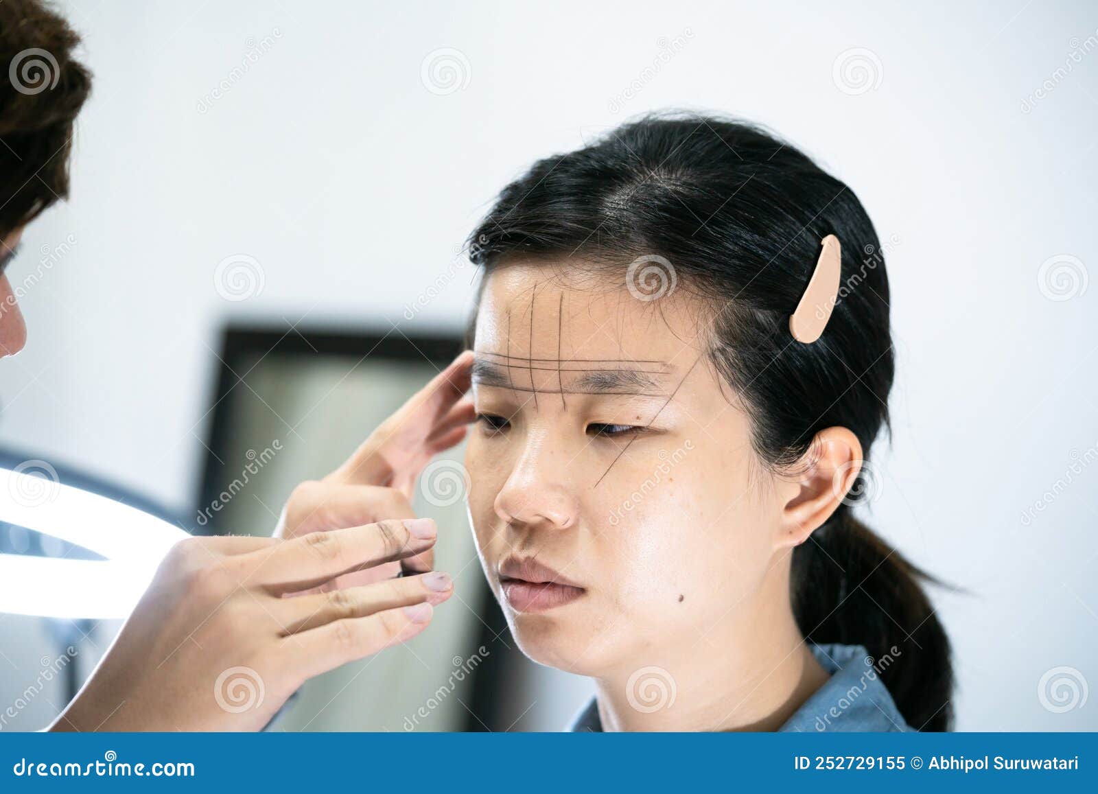 The Process of Shaping Eyebrows by a Beauty Master with a Thread for a ...