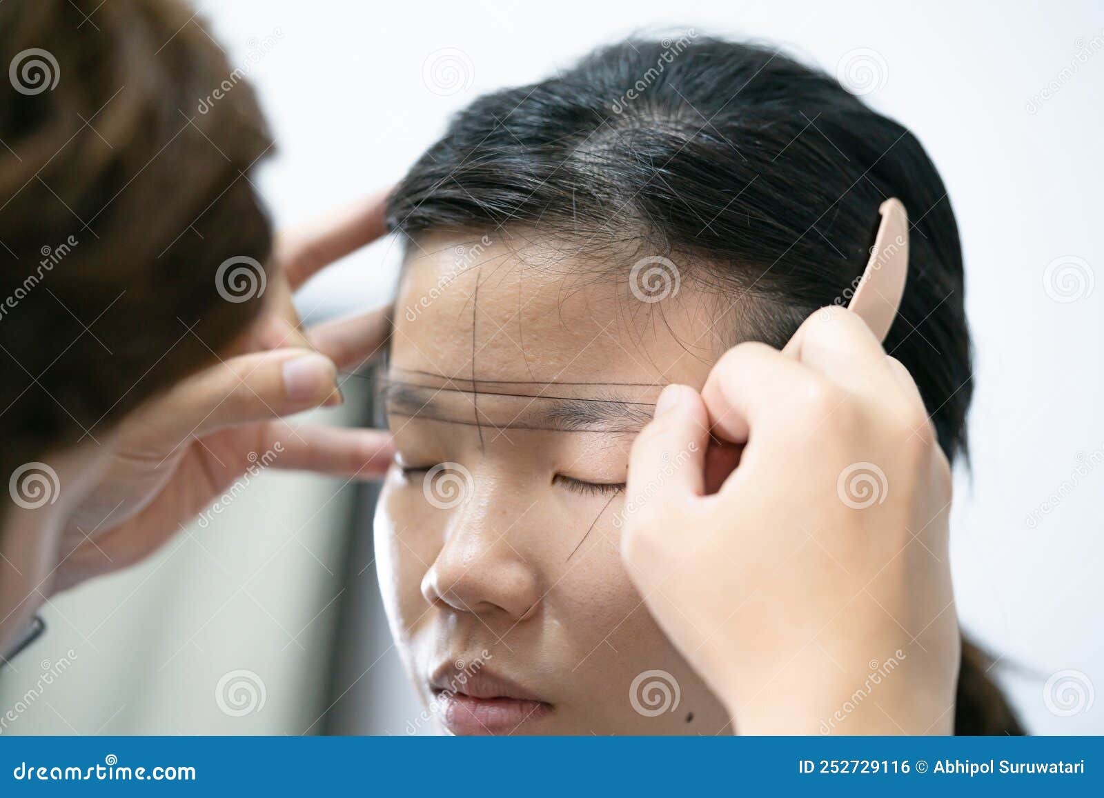 The Process of Shaping Eyebrows by a Beauty Master with a Thread for a ...