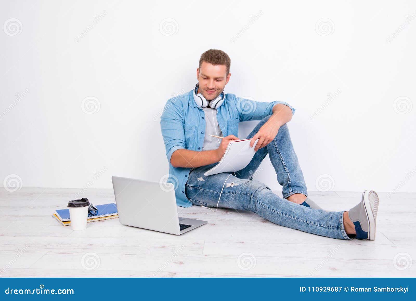 Process of Studying. Preoccupied Attractive Guy is Sitting on Th Stock ...