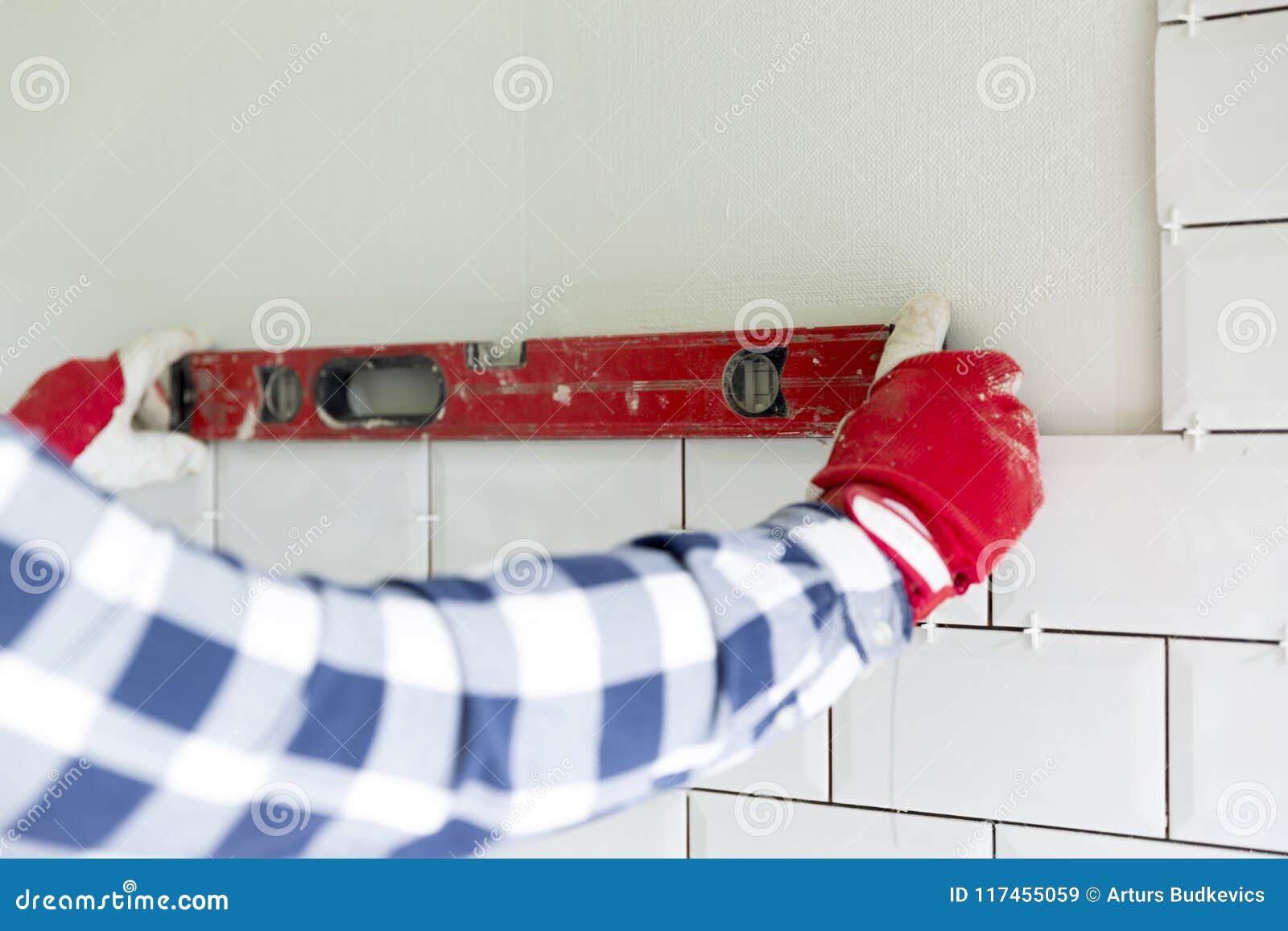 Process of Tiling the Tiles in the Kitchen. Contractor Measuring Stock ...