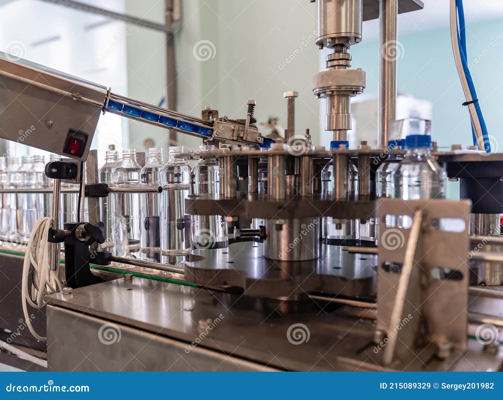 The Process of Twisting the Lids on Plastic Bottles. Water Production ...