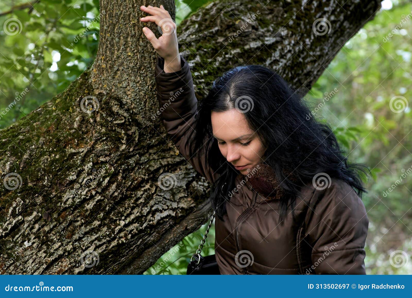 Serious Young Mysterious Brunette Woman.Spreading Tree in an Overgrown ...