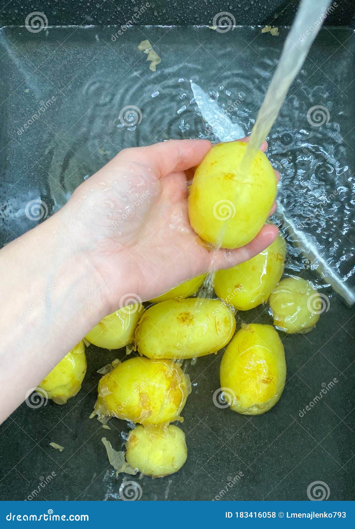 The Process of Washing Potatoes Under Running Water in a Sink in the ...