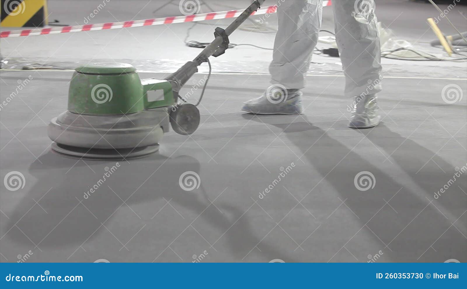A Builder Works with an Industrial Grinder on a Concrete Floor. Floor ...
