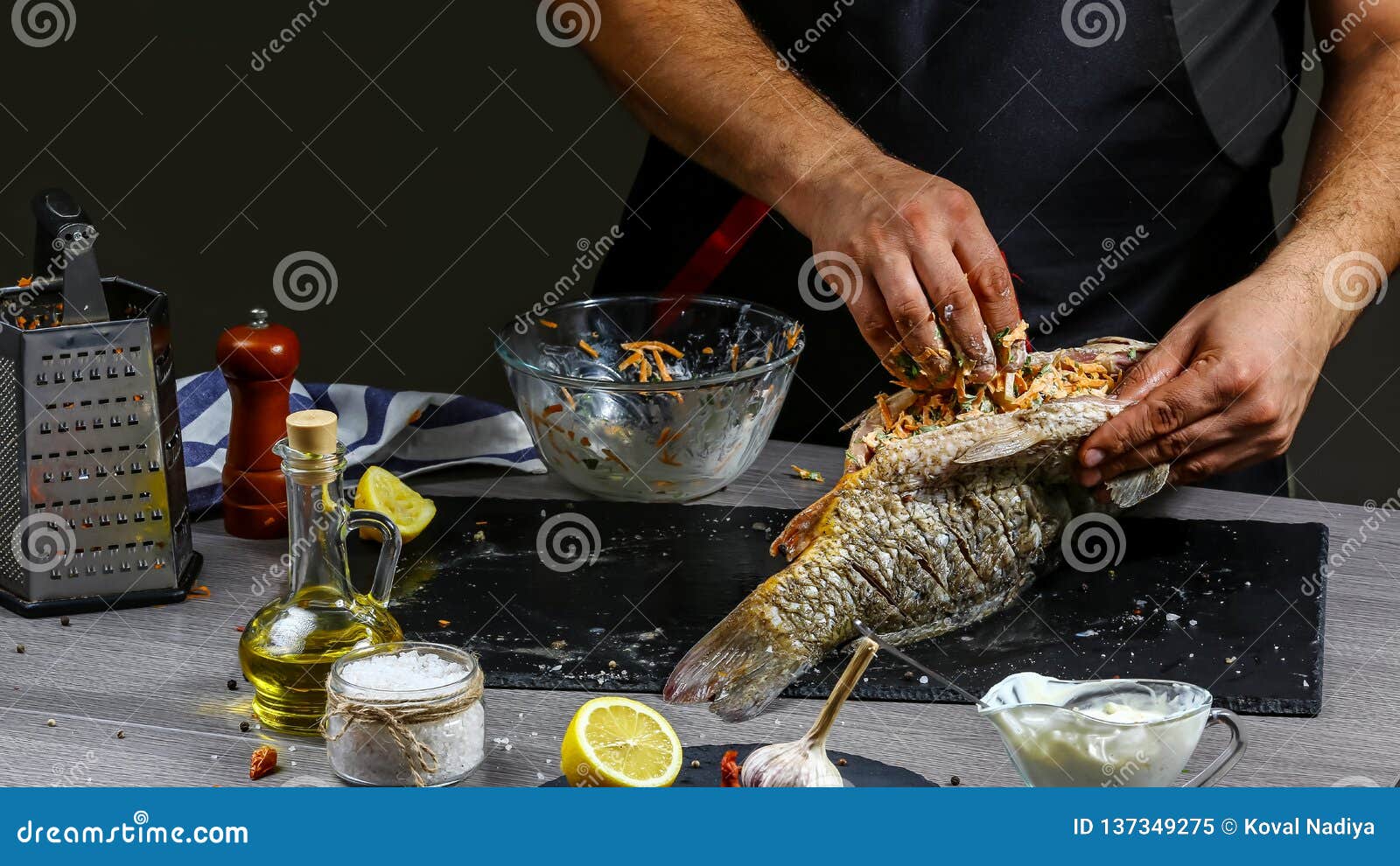 Processing of Cooking Fish. Carp Fish with Various Ingredients Lemon ...