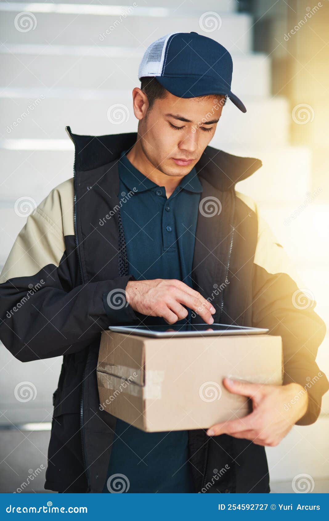 Processing His Deliveries the Digital Way. a Courier Using a Digital ...