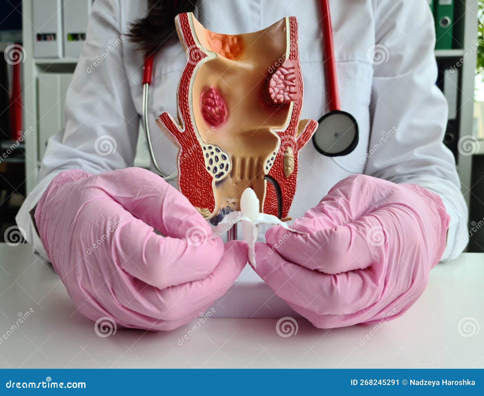 Proctologist Doctor Inserting Rectal Suppository into Artificial Model ...