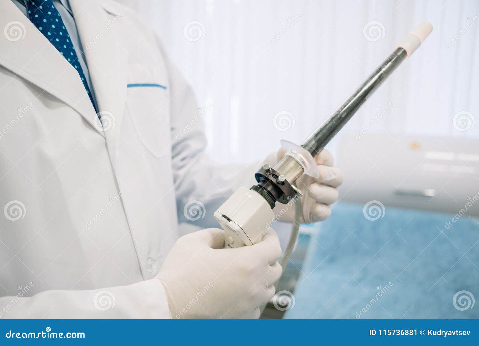 Proctologist Holding An Anoscope Against A Proctological Chair. Stock ...
