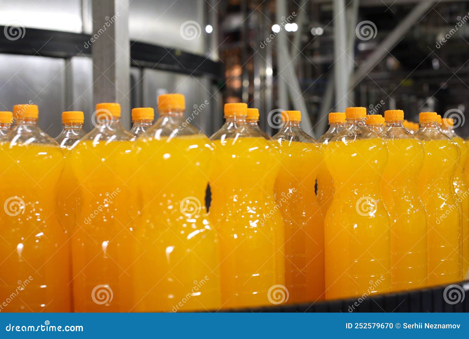 Production of Carbonated Drinks. Orange Bottles on the Production Line ...