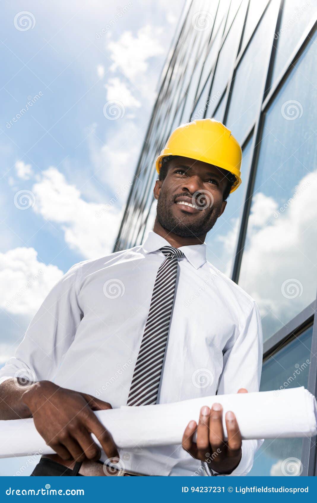 Professional Architect in Hard Hat Holding Blueprint Outside Modern ...