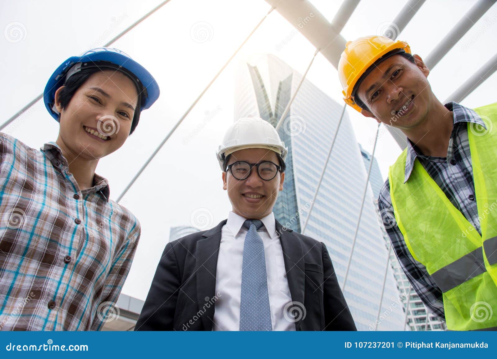 Professional Asian Engineering Team Wearing Safety Helmet Looking at ...