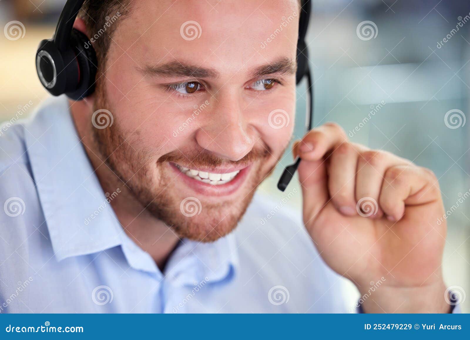 Professional Assistance at Your Service. a Young Man Using a Headset in ...