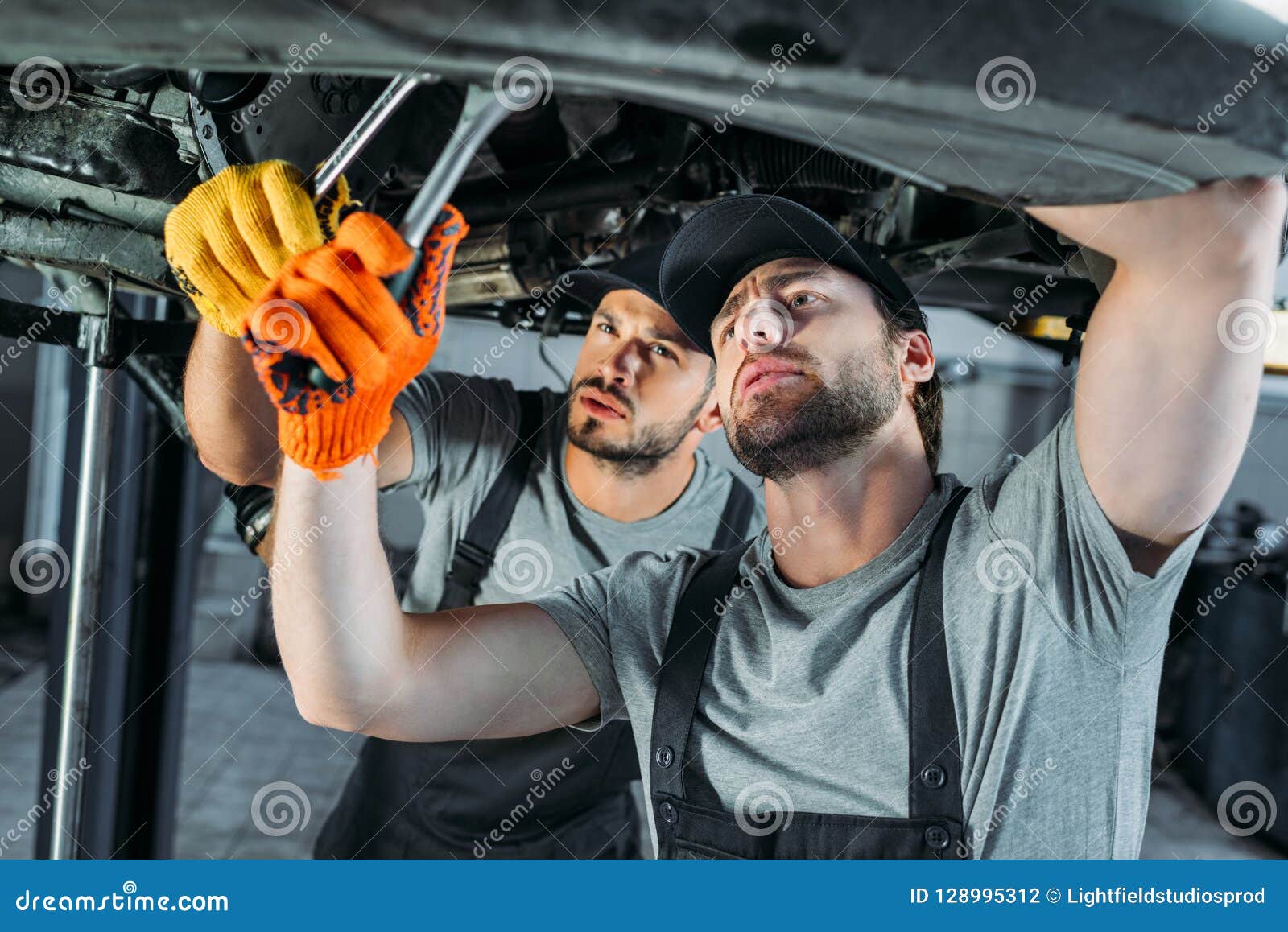 Professional Auto Mechanics Working with Car and Tools Stock Photo ...
