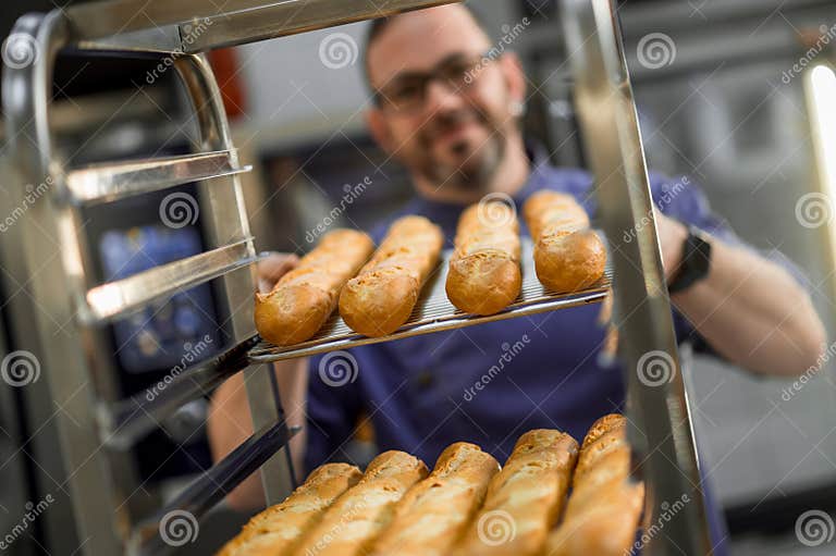 Professional Baker at Bakery with Bread Baguette Stock Image - Image of ...