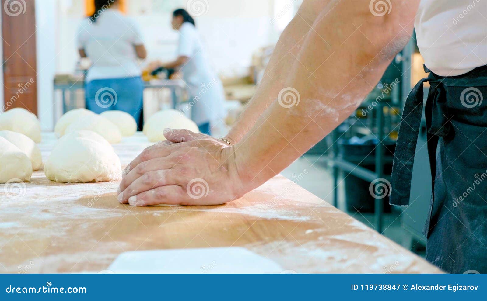 Professional Baker is Forming Pieces of Dough in Bakery Commercial ...