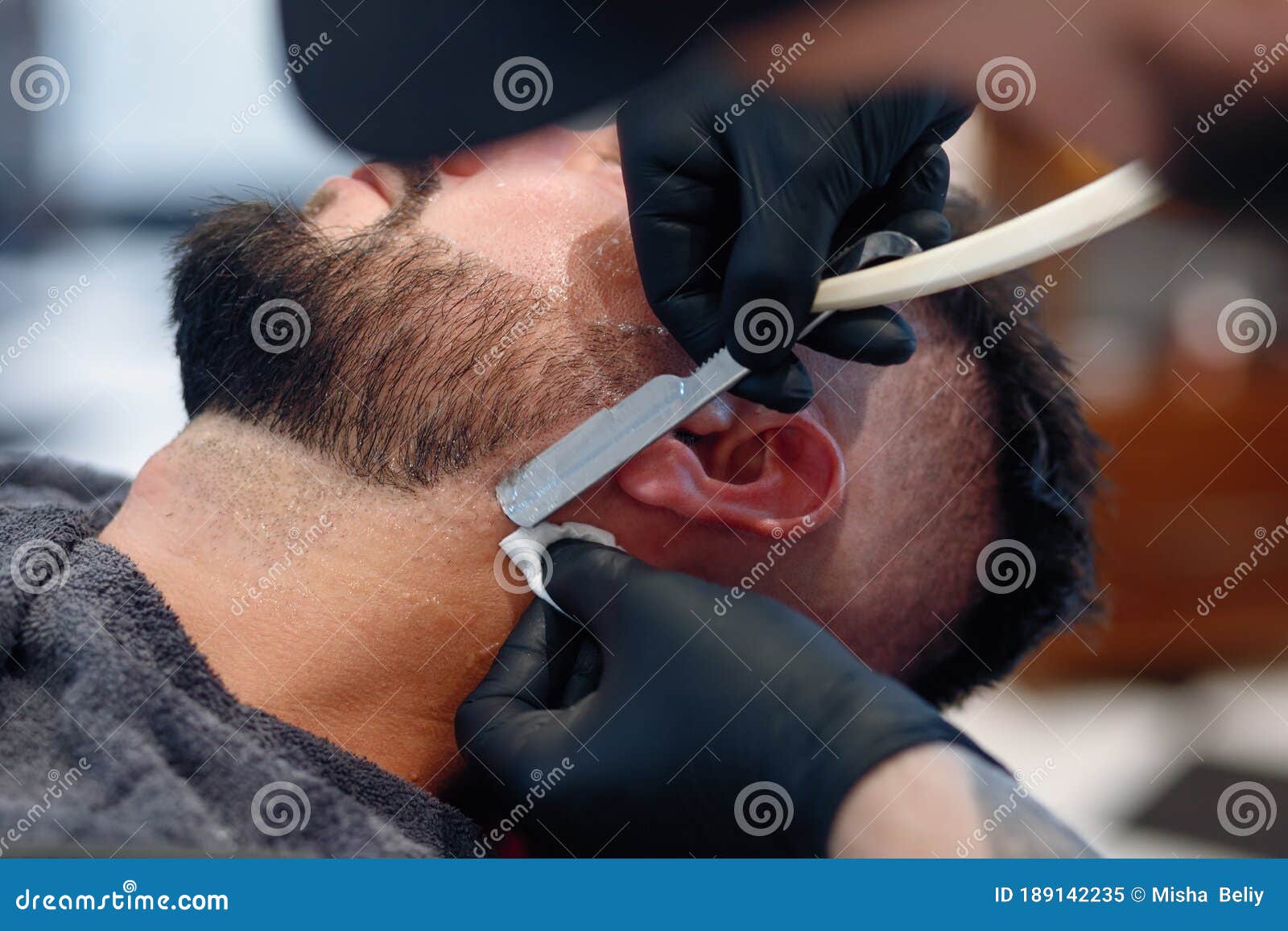 Professional Barber Shaves Customer Beard with Straight Razor Stock ...