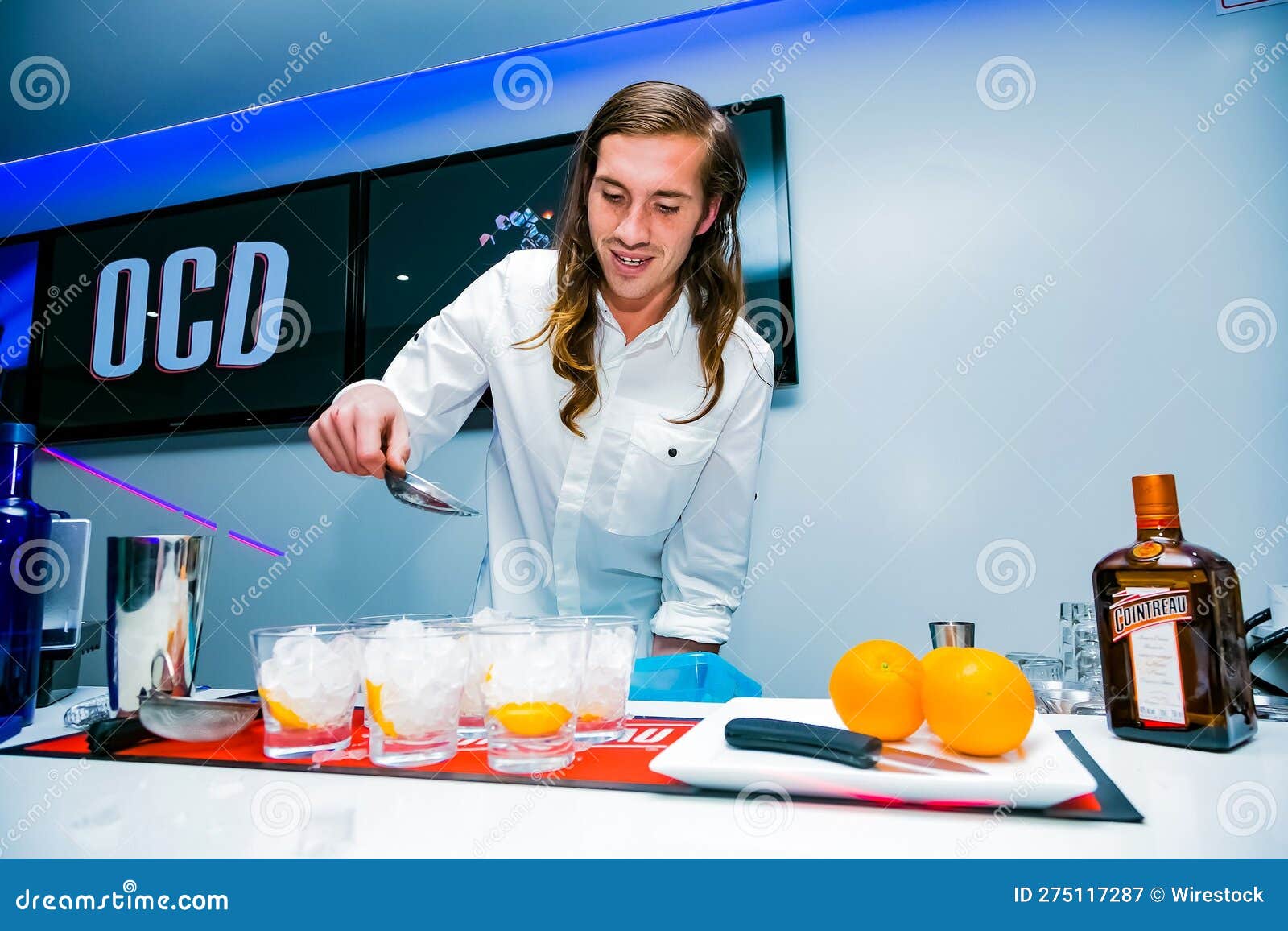 Professional Bartender is Carefully Crafting Cocktails in Front of a ...