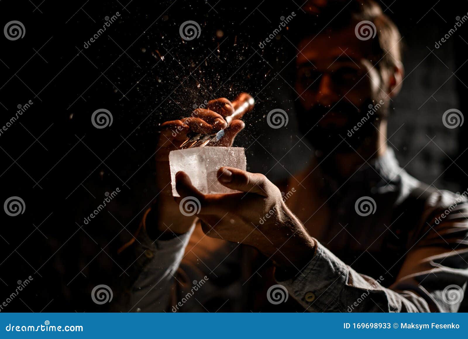 Professional Bartender Cutting Ice with a Special Fork in Bar in the ...