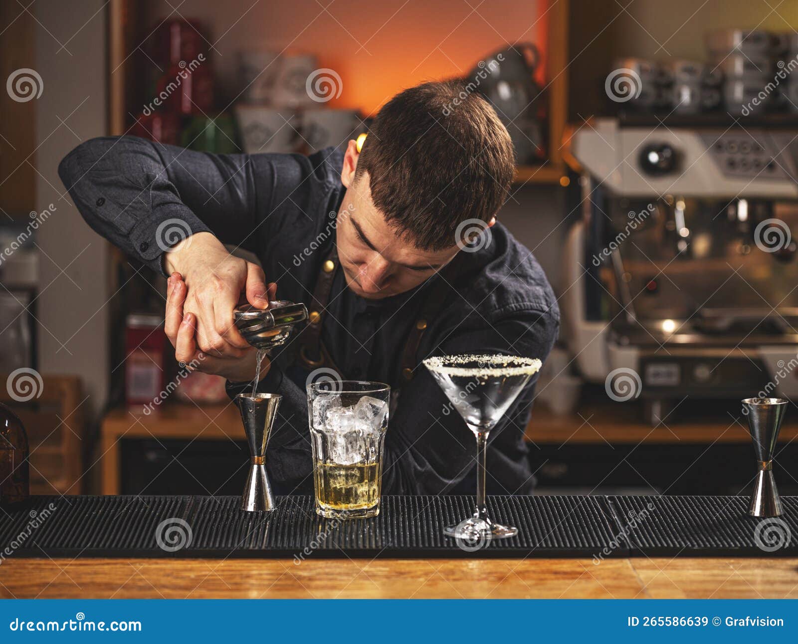 Professional Bartender Pouring A Delicious Cocktail From The Steel ...
