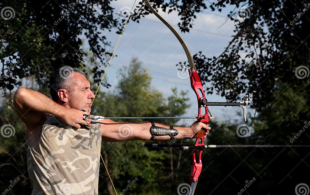 Professional Bowman Aiming with Bow and Arrow Stock Photo - Image of ...